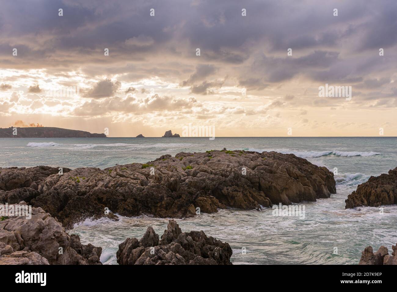 a view of the coast with rocks and clouds Stock Photo - Alamy
