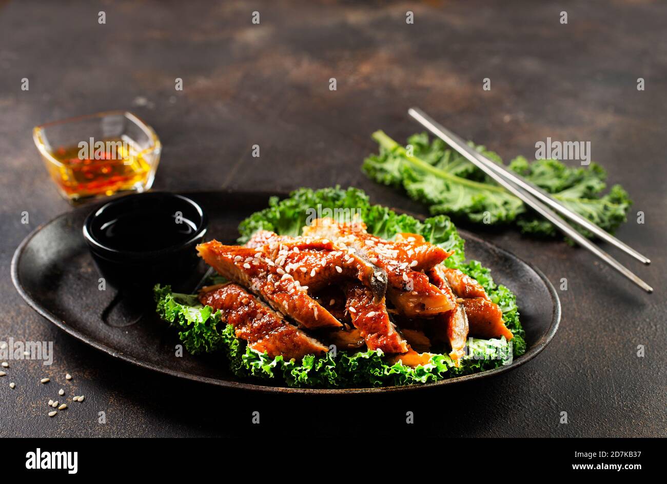Japanese eel grilled or Unagi ibaraki set on plate, eel with sesame and ...