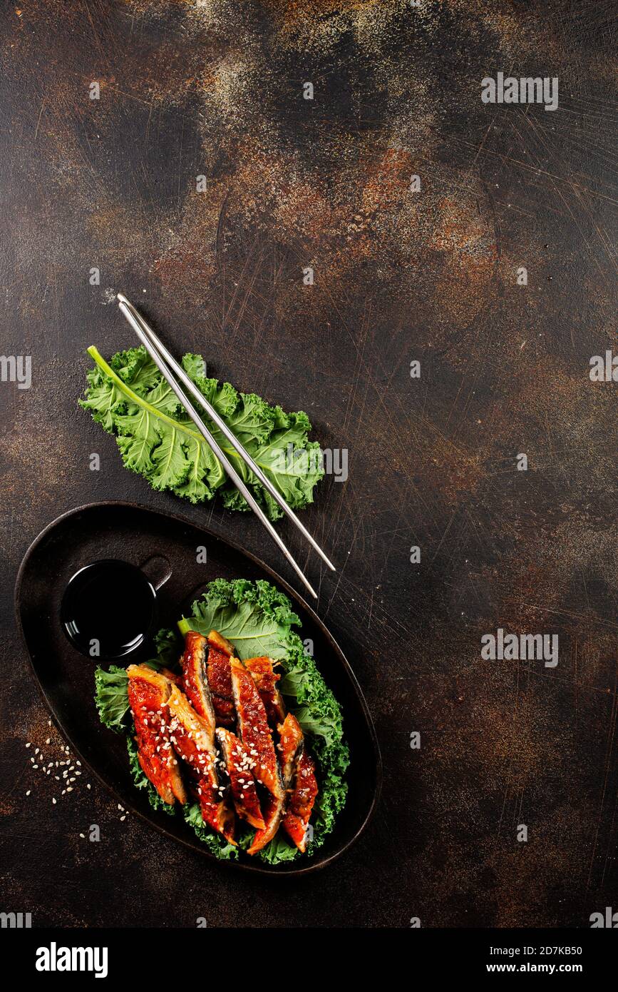 Japanese eel grilled or Unagi ibaraki set on plate, eel with sesame and ...