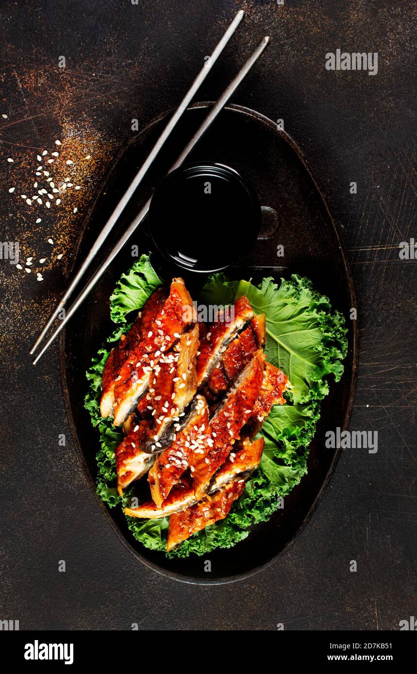 Japanese eel grilled or Unagi ibaraki set on plate, eel with sesame and ...