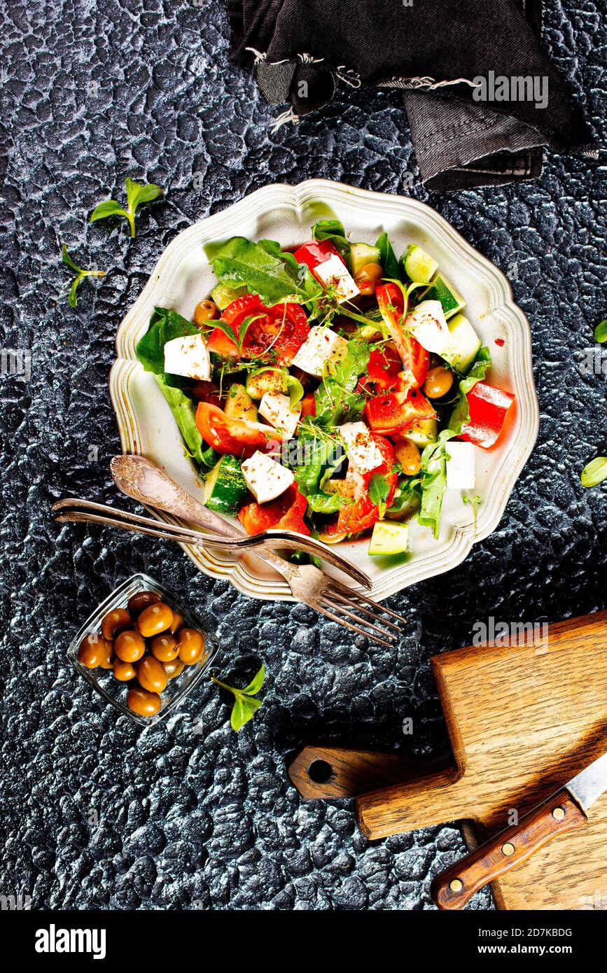 greek salad on metal plate, salad with feta cheese Stock Photo - Alamy