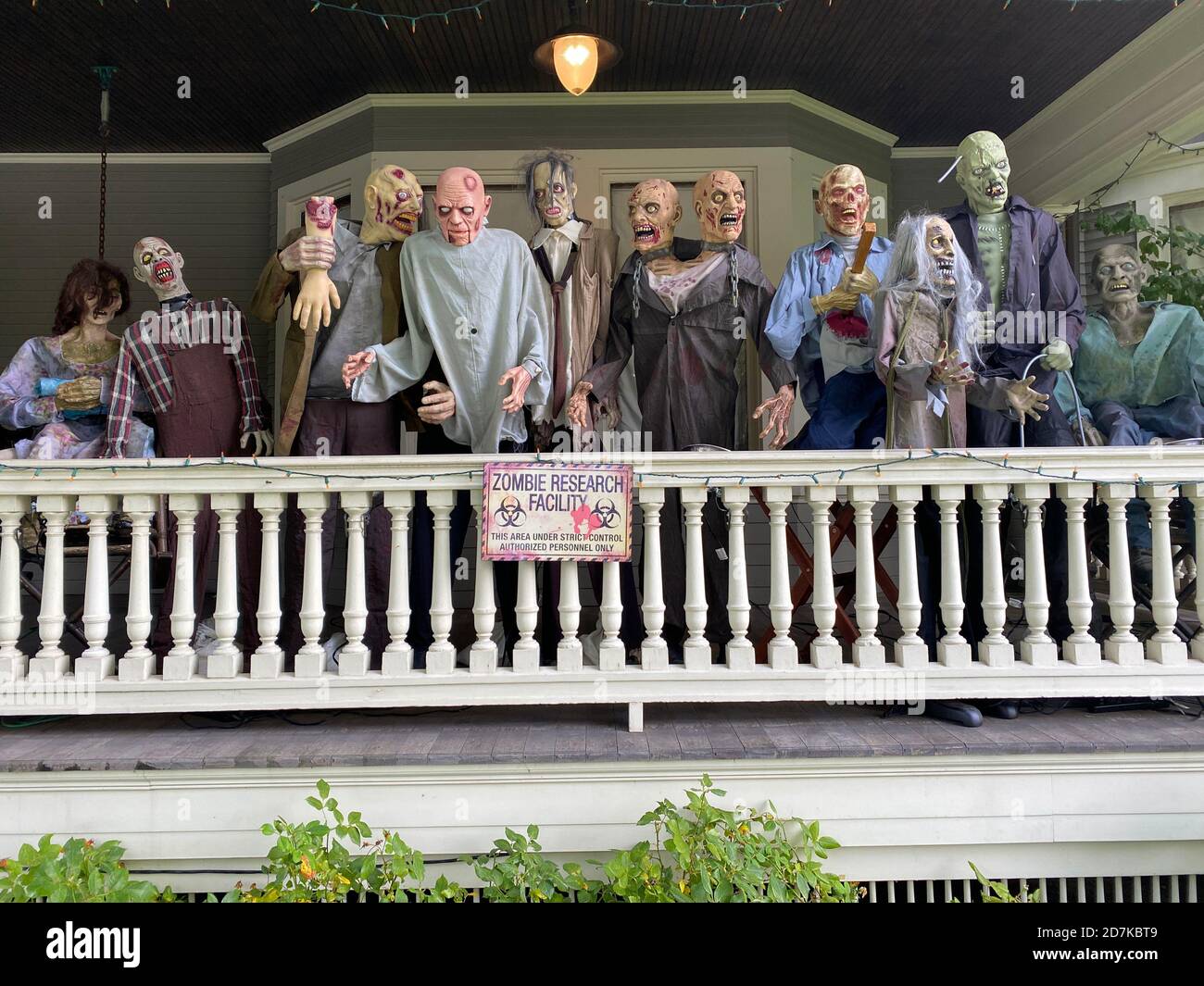 Scary Halloween installation on the porch of a large victorian house in ...