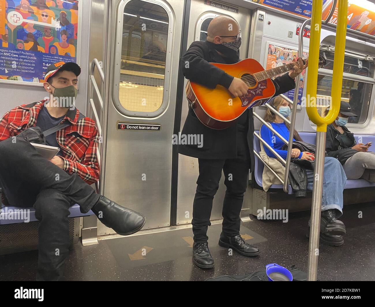 Singer performs on a New York City subway train for tips in Brooklyn ...