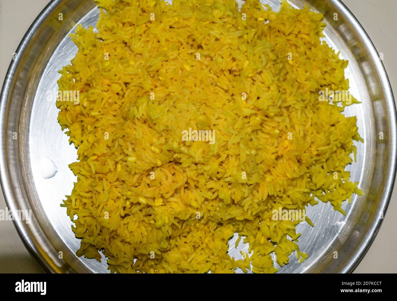 Yellow fried rice served on steel plate looking awesome Stock Photo - Alamy