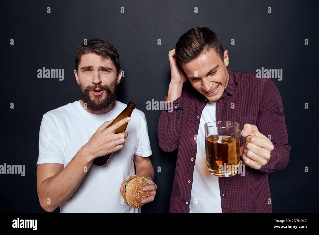 Two drunk friends drinking beer rest fun dark background Stock Photo ...