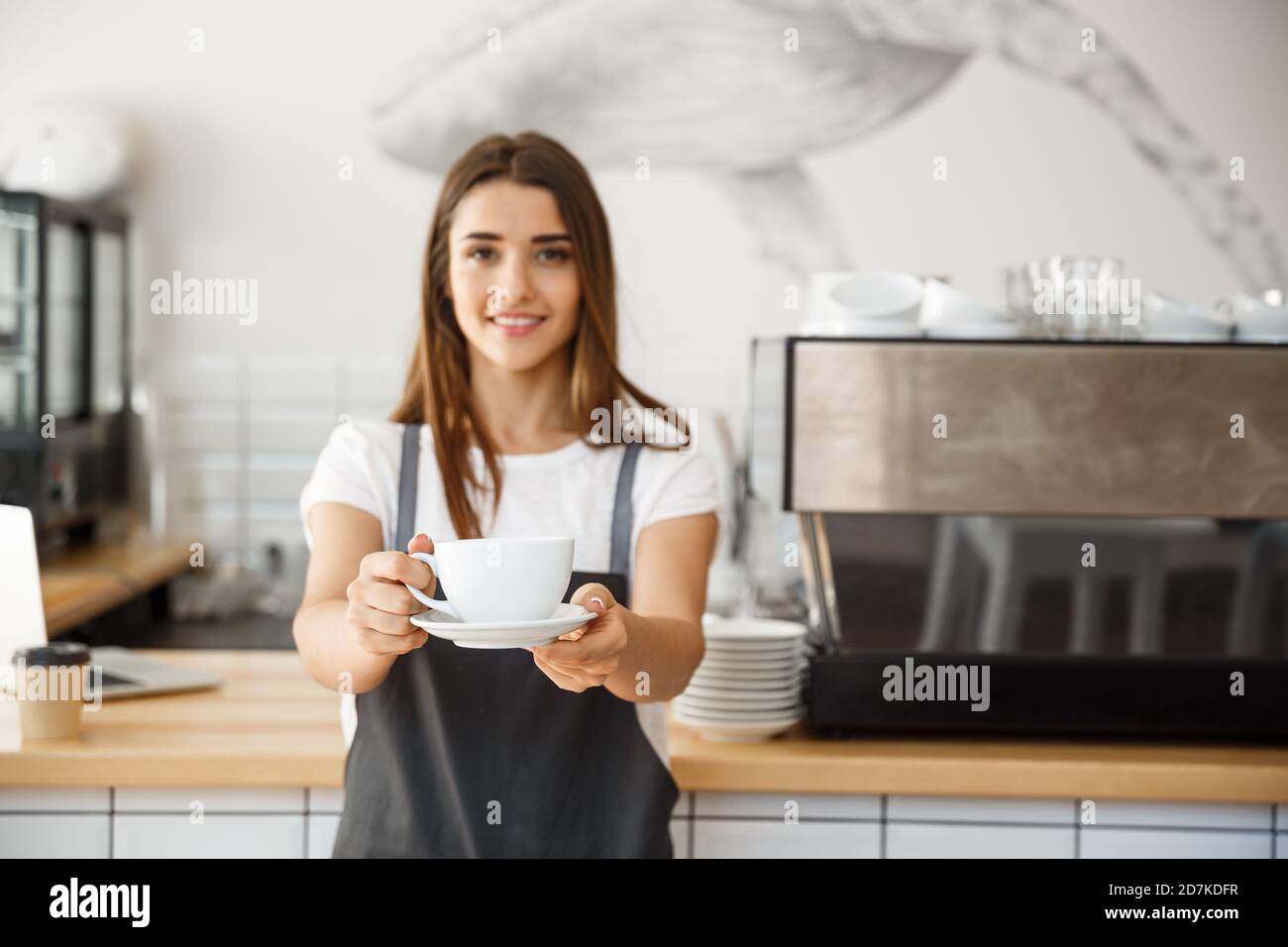 Coffee Business Concept - Caucasian female serving coffee while ...