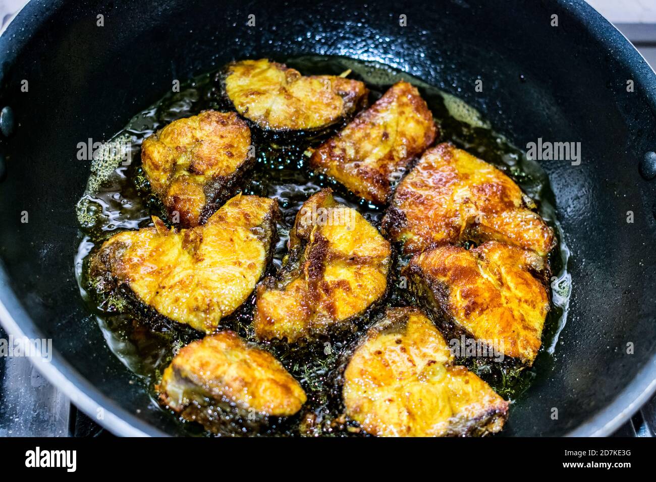 Deep frying cut fish in low flame looking delicious Stock Photo - Alamy