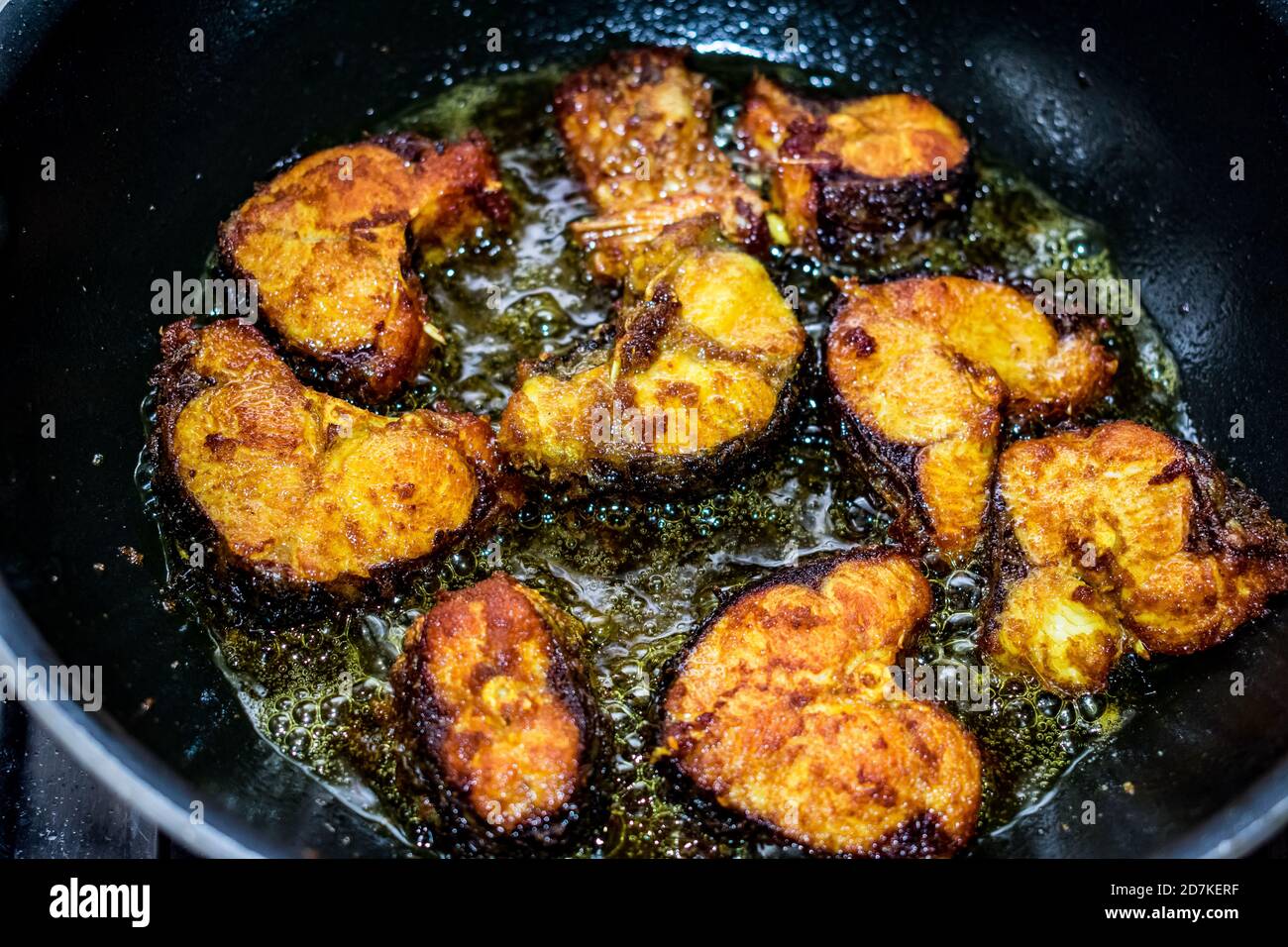 Deep frying cut fish in low flame looking delicious Stock Photo - Alamy