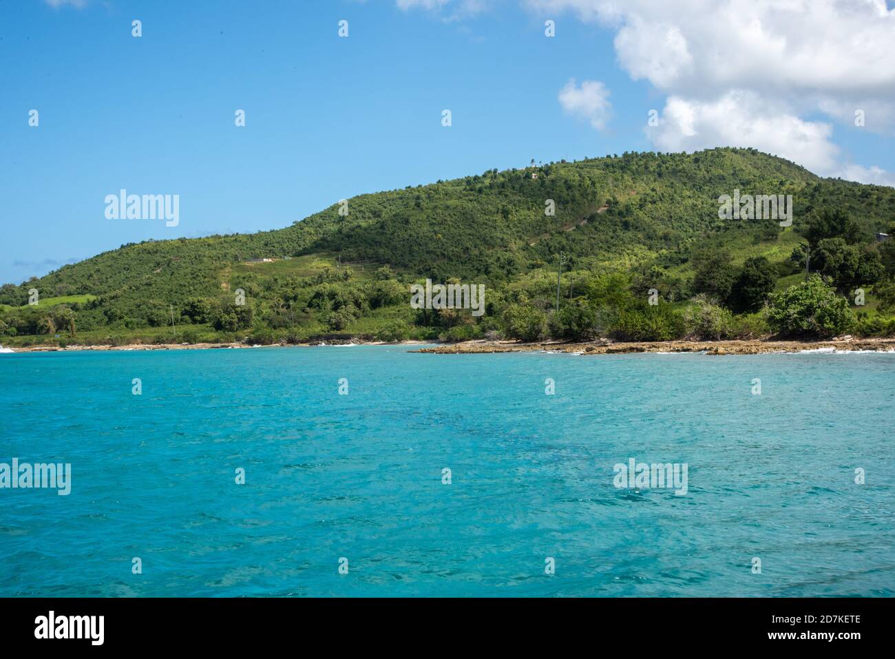 Stunning rolling, green landscape with turquoise Caribbean sea and ...