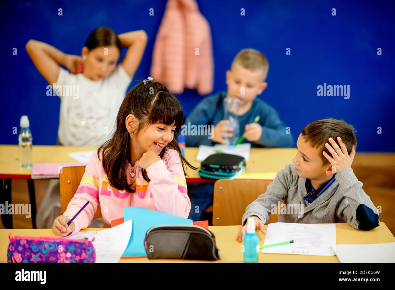 Elementary schoolchildren writing at the desk in the classroom Stock ...