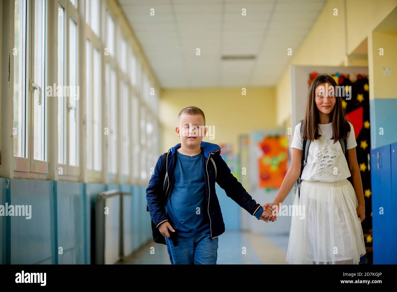 Elementary Students Walking In Hallway