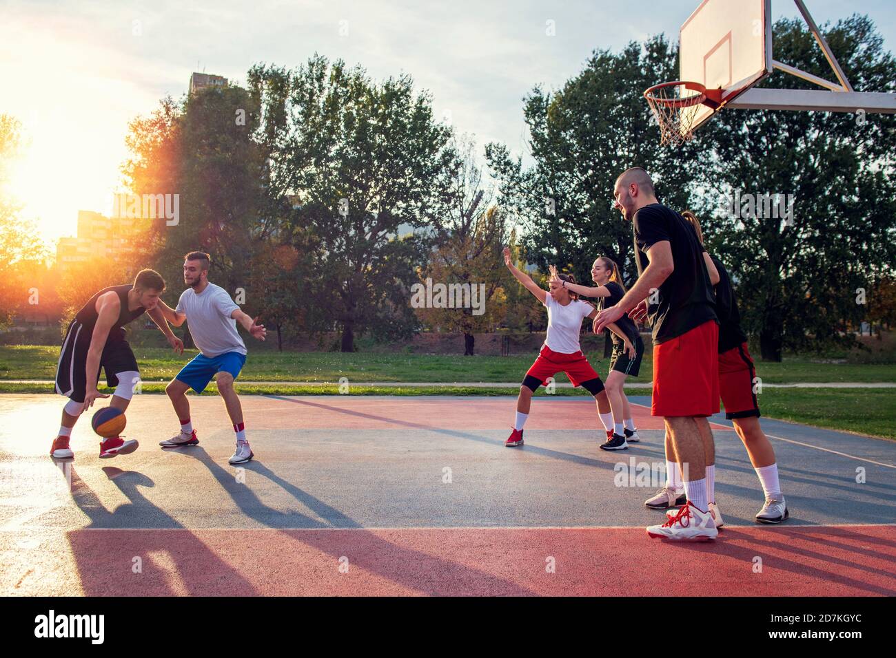 Group Of Young Friends Playing Basketball Match Stock Photo - Alamy