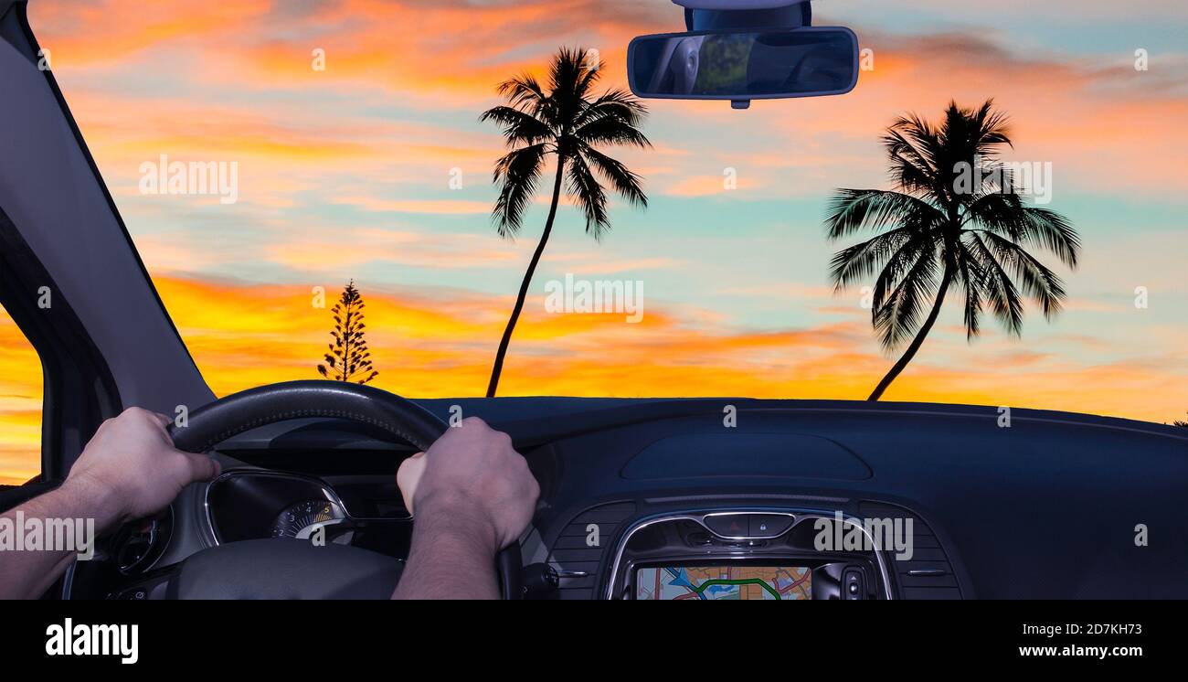 Driving a car towards a tropical sunset in Moorea, French Polynesia ...