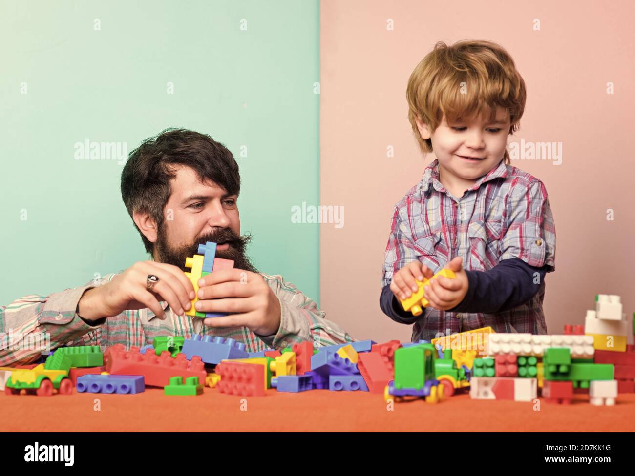 Dad and kid build of plastic blocks. Useful toy. Child care development ...