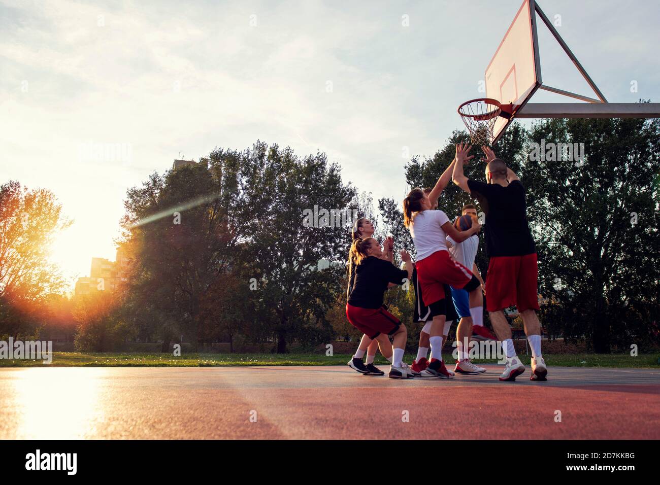 Group Of Young Friends Playing Basketball Match Stock Photo - Alamy