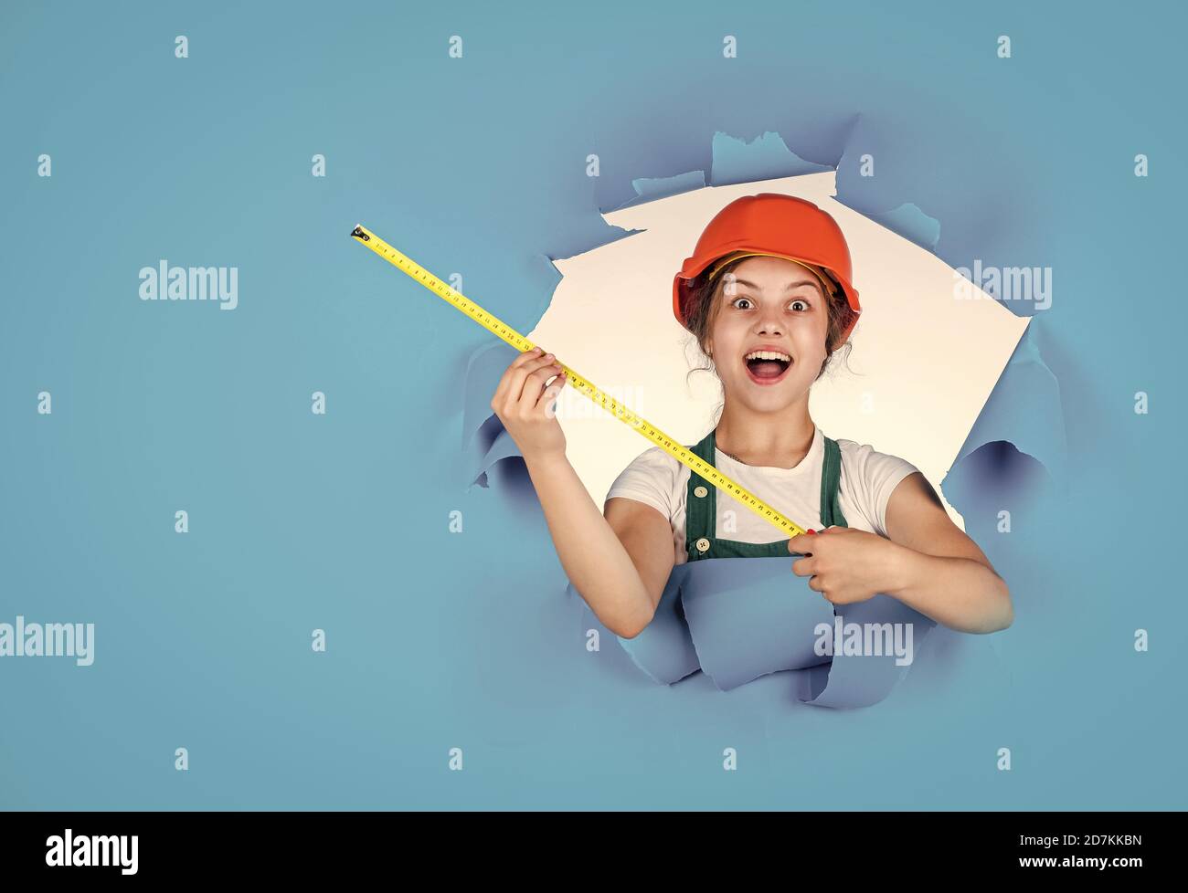 Little girl using a measuring tape. construction worker with tape ...