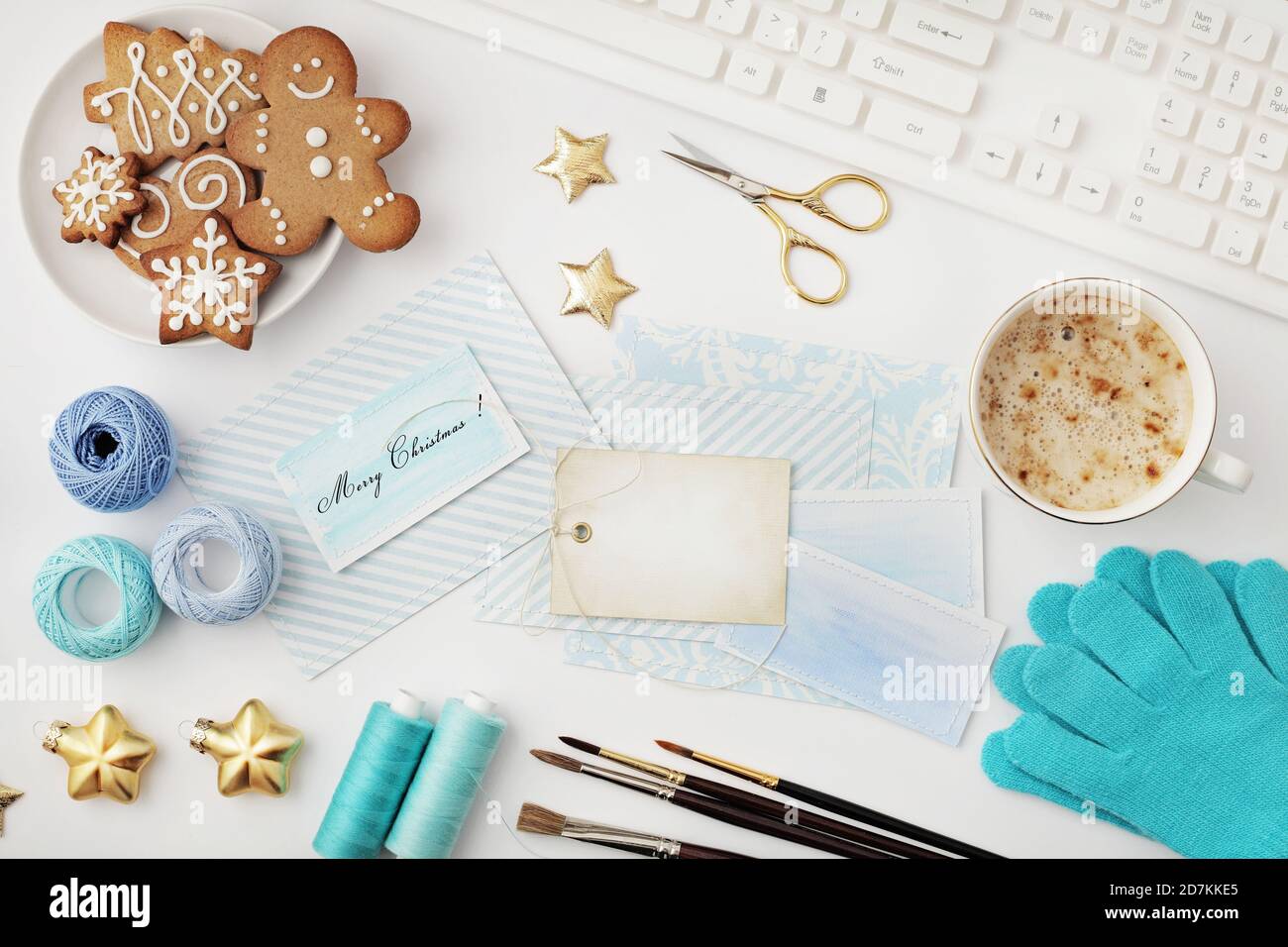 christmas workspace with notebook keyboard, sketchbook, christmas gifts ...