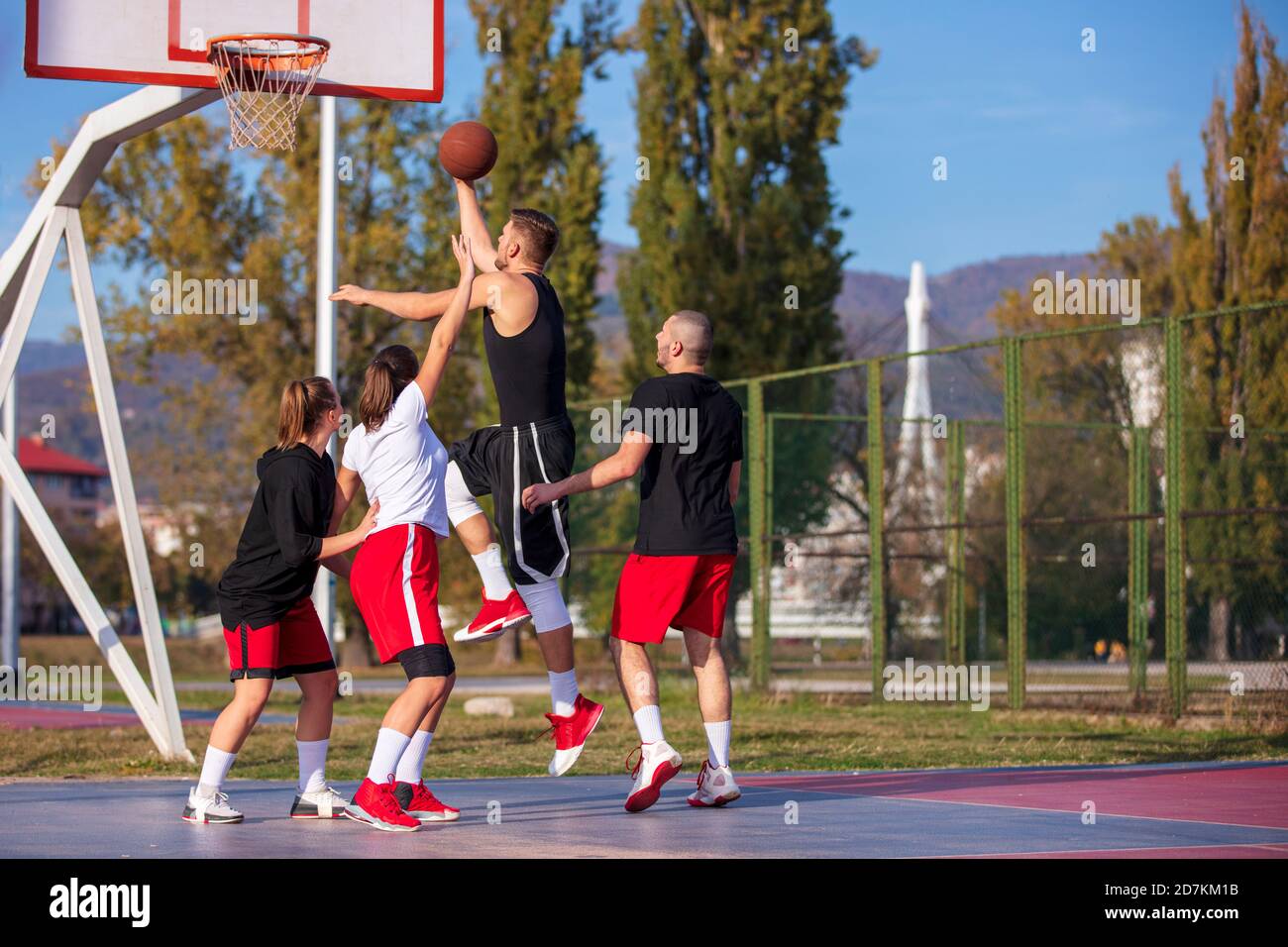 Group Of Young Friends Playing Basketball Match Stock Photo - Alamy