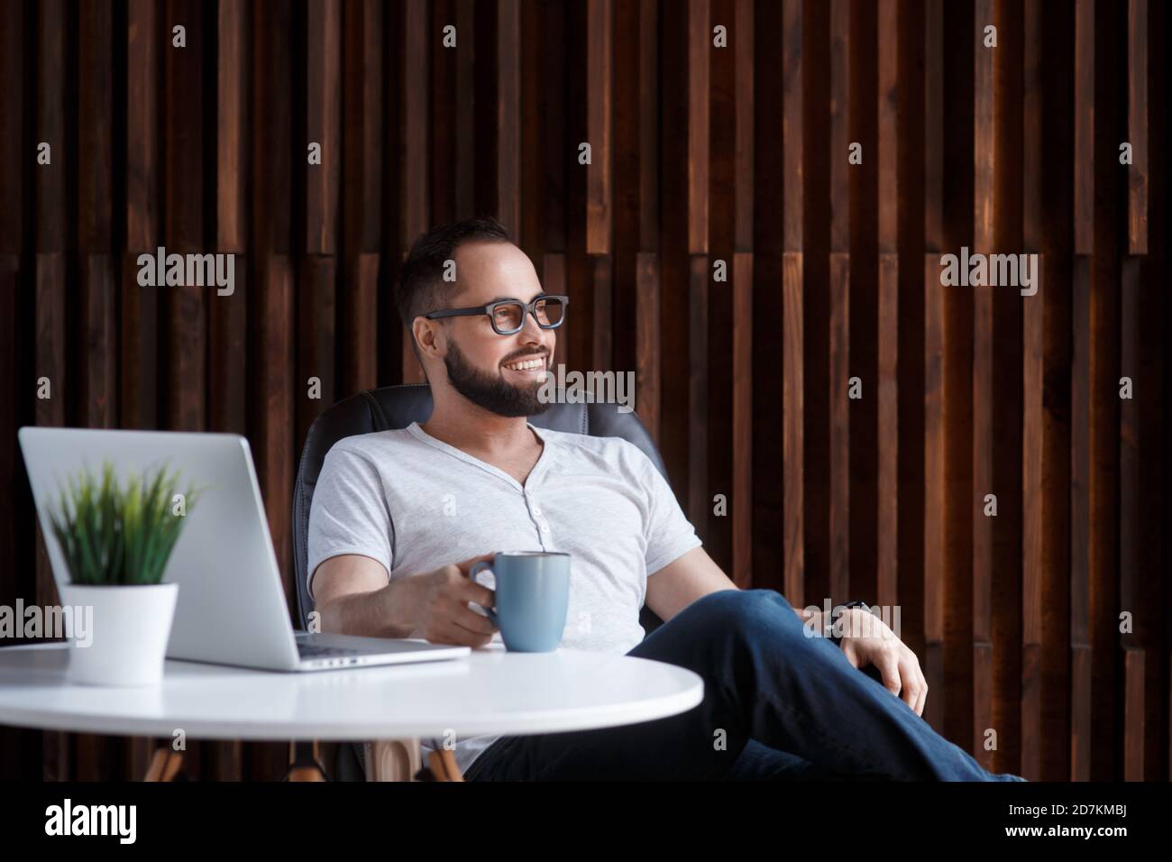 Young successful bearded businessman freelancer in office coworking ...