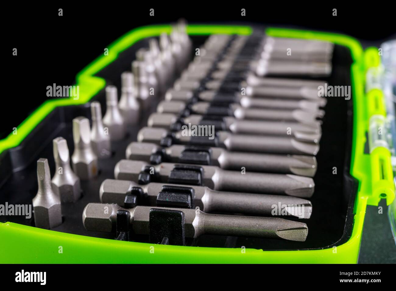 Bits for unscrewing special screws. Special keys in a container. Dark ...