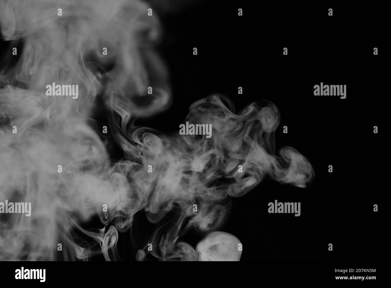 White smoke on a black background. Texture of smoke. Clubs of white ...