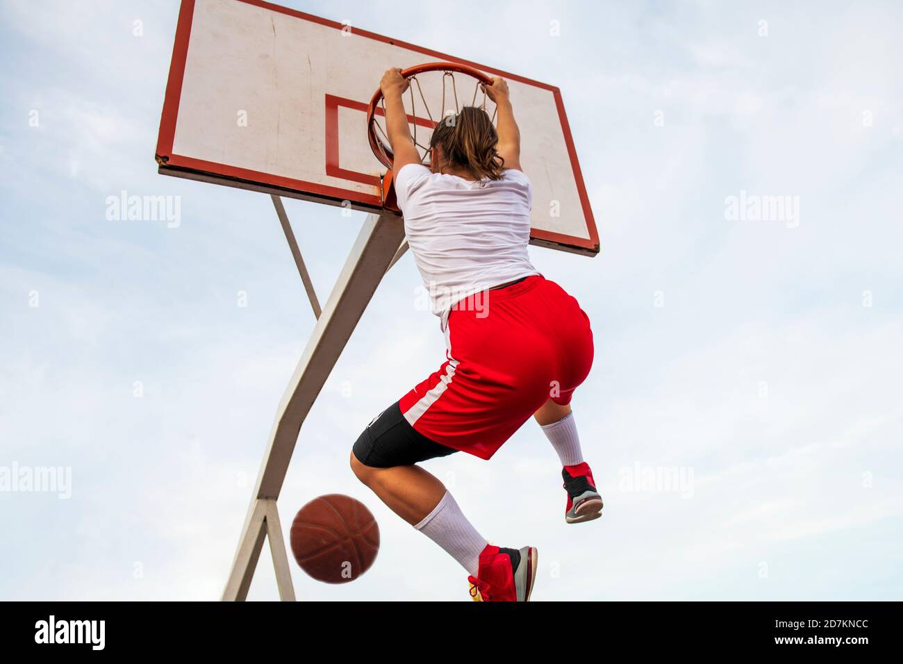 Females playing basketball on street court. Woman streetball player ...