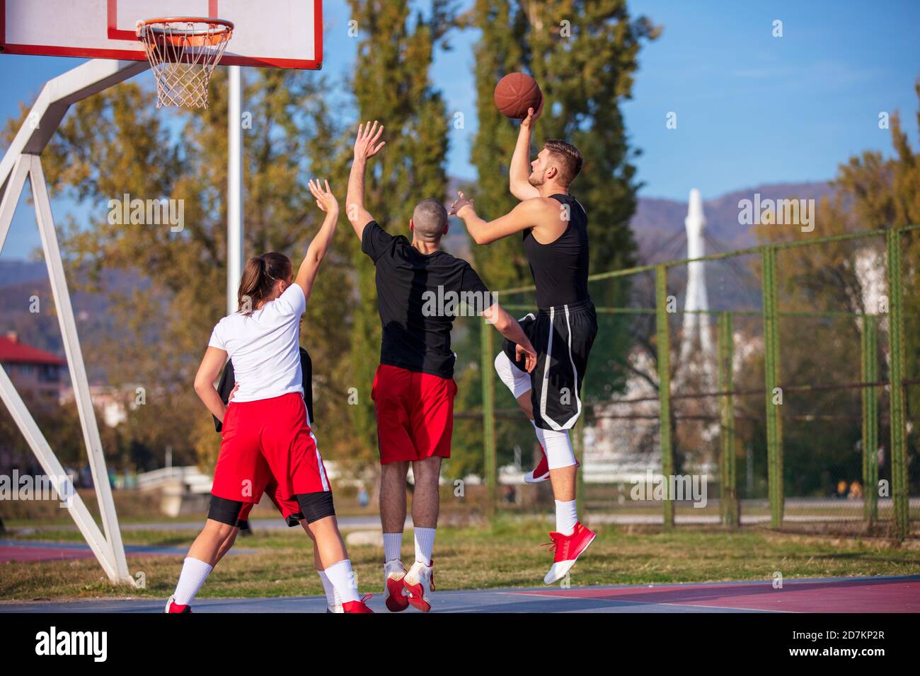 Group Of Young Friends Playing Basketball Match Stock Photo - Alamy