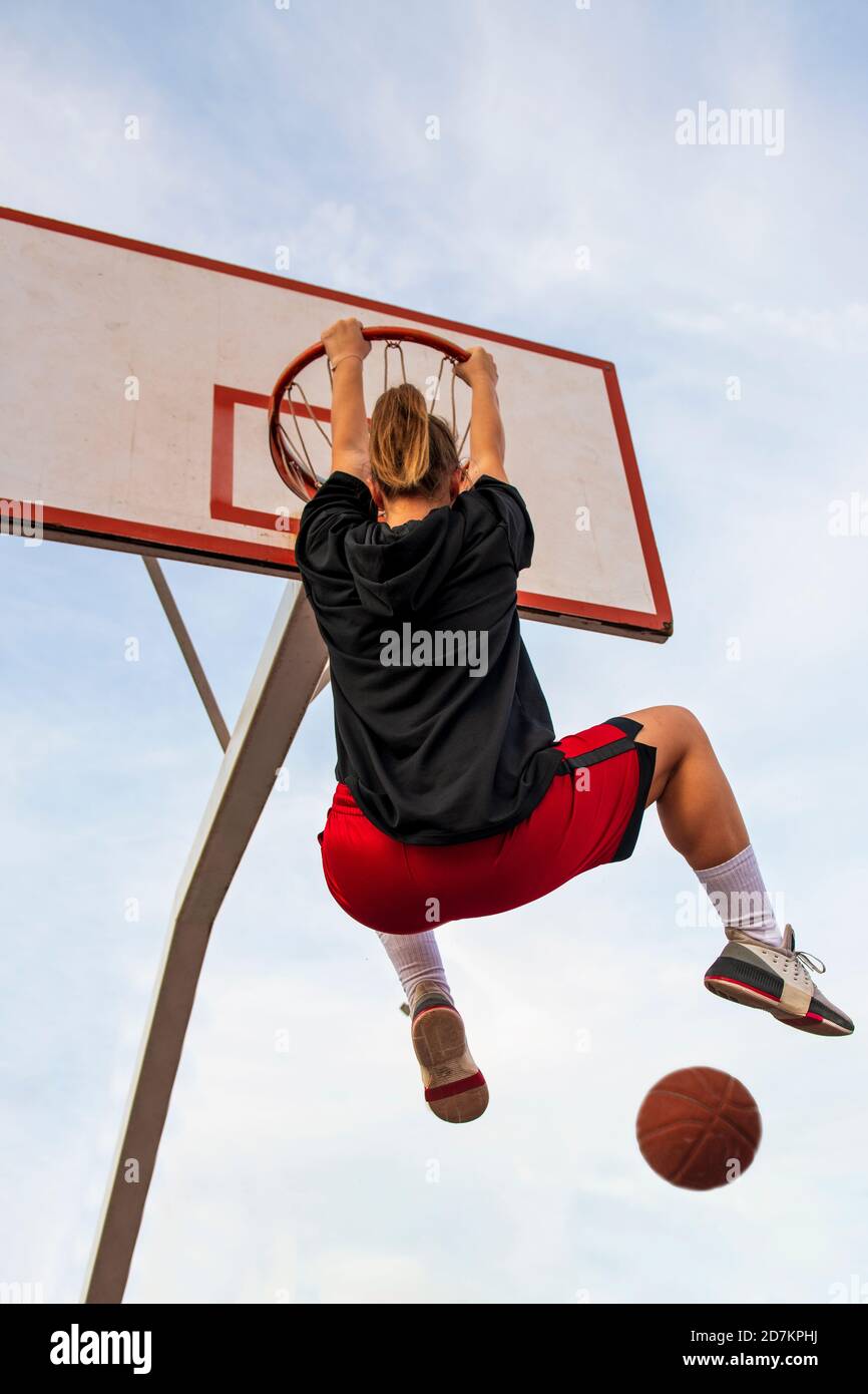 Females playing basketball on street court. Woman streetball player ...