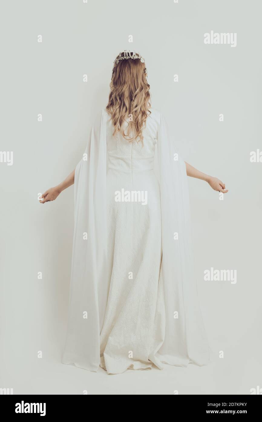 Beautiful woman back in white dress on white background Stock Photo - Alamy