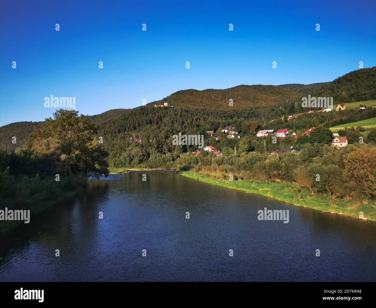 The river flows among the autumn Beskid Sadecki mountains. The Poprad ...