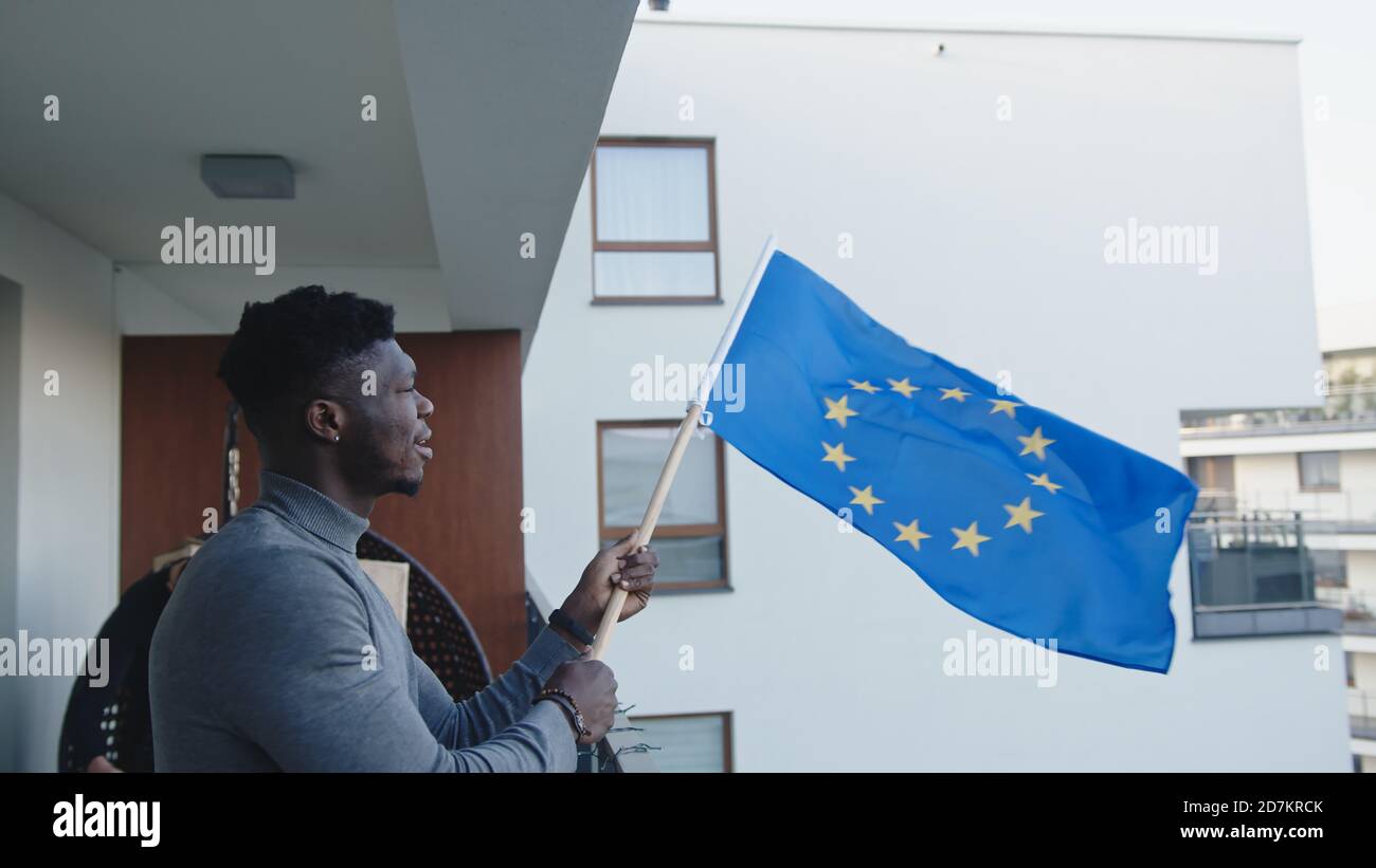 Young attractive black man waving European Union flag. High quality ...
