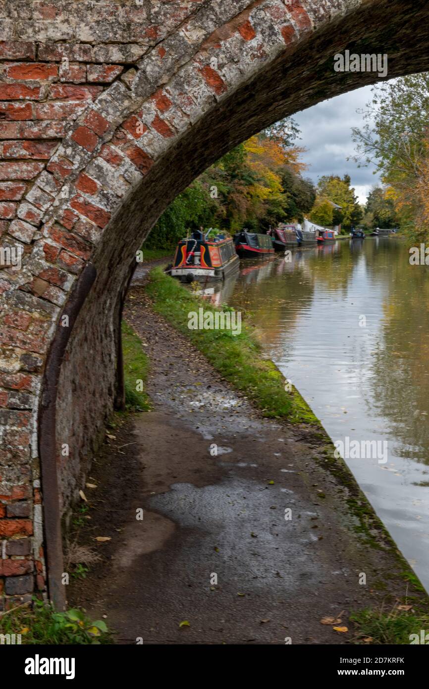 a bridge over the grand union canal at braunston in northamptonshire with narrow boats and ...