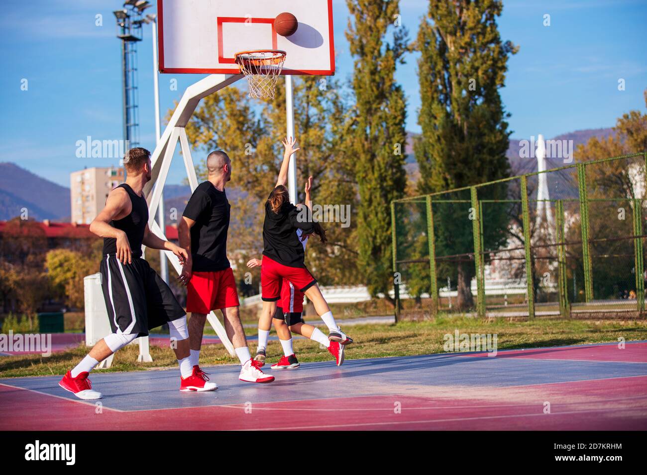 Group Of Young Friends Playing Basketball Match Stock Photo - Alamy