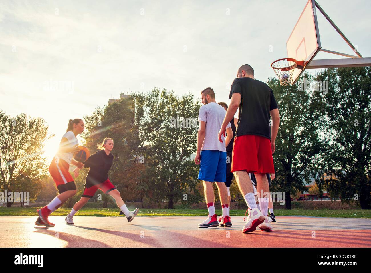 Group Of Young Friends Playing Basketball Match Stock Photo - Alamy