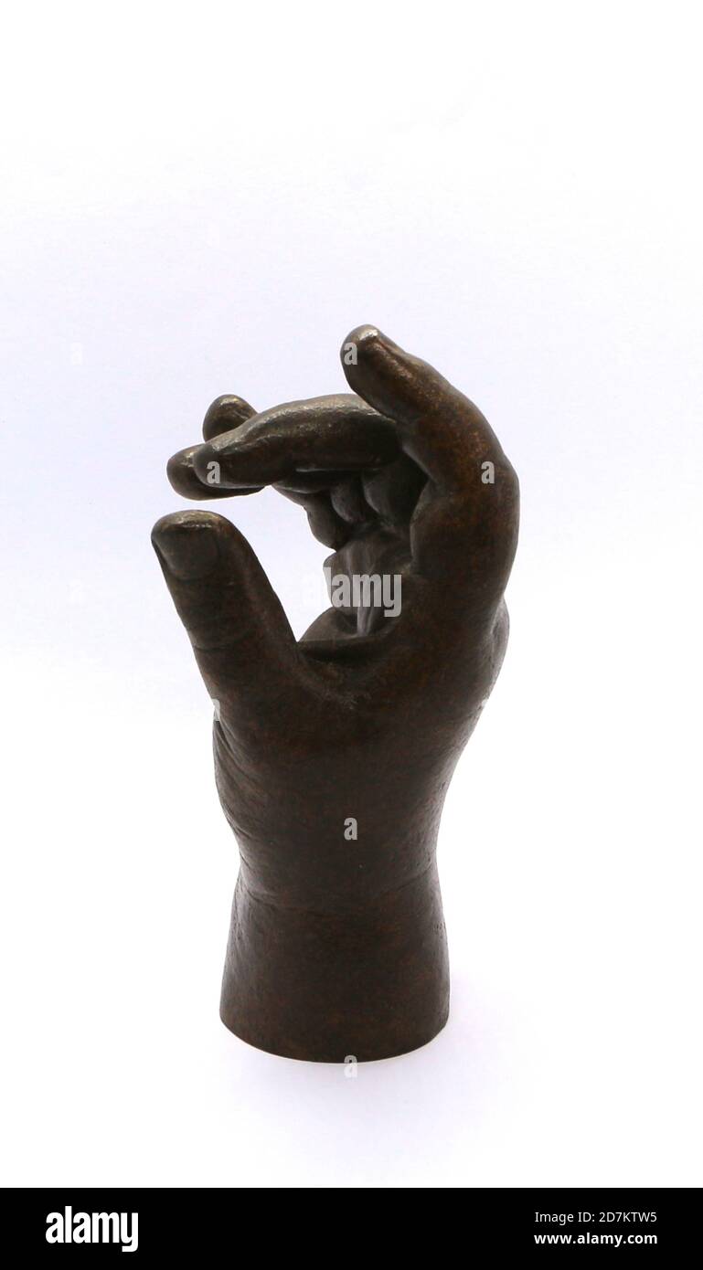 Photo of a Child's hand sculpture cast in bronze and strongly lit ...