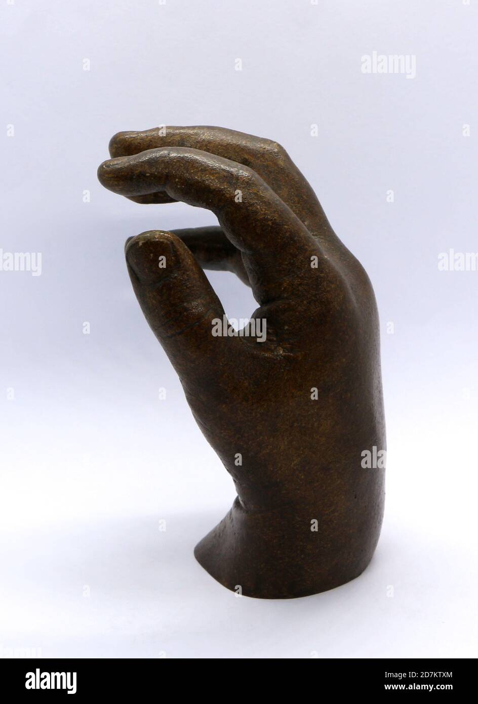 Photo of a Child's hand sculpture cast in bronze and strongly lit ...