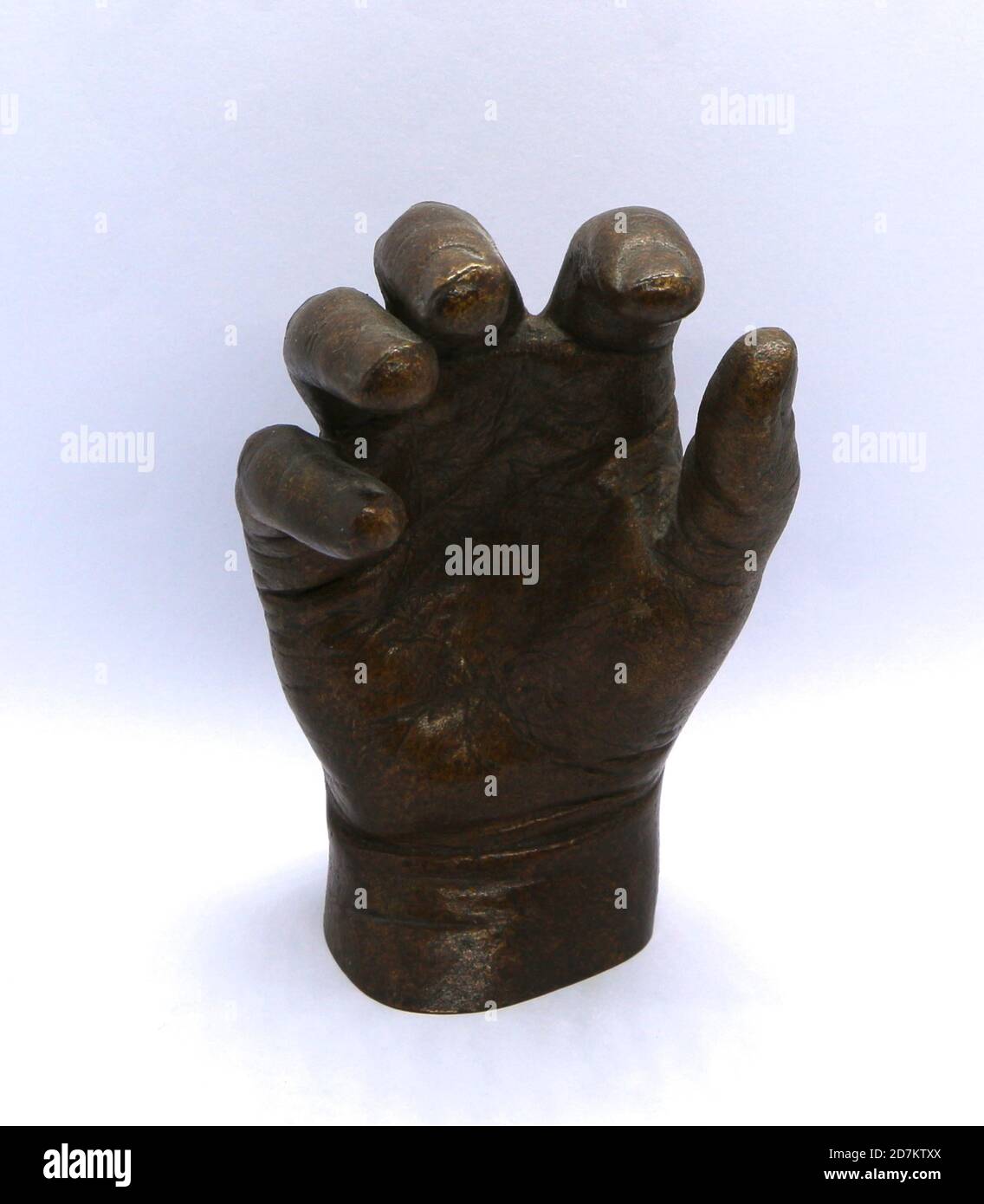 Photo of a Child's hand sculpture cast in bronze and strongly lit ...