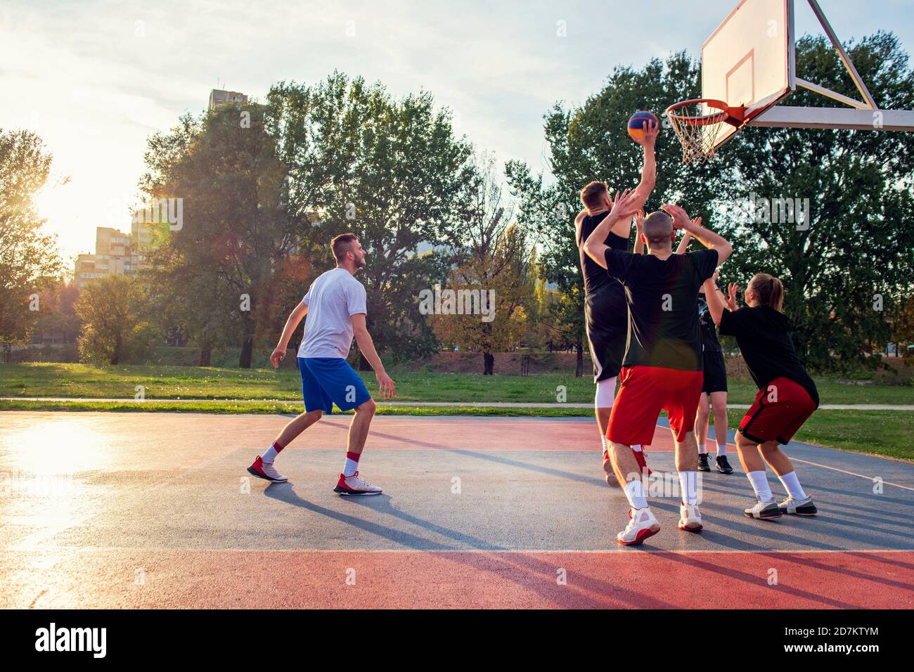 Group Of Young Friends Playing Basketball Match Stock Photo - Alamy