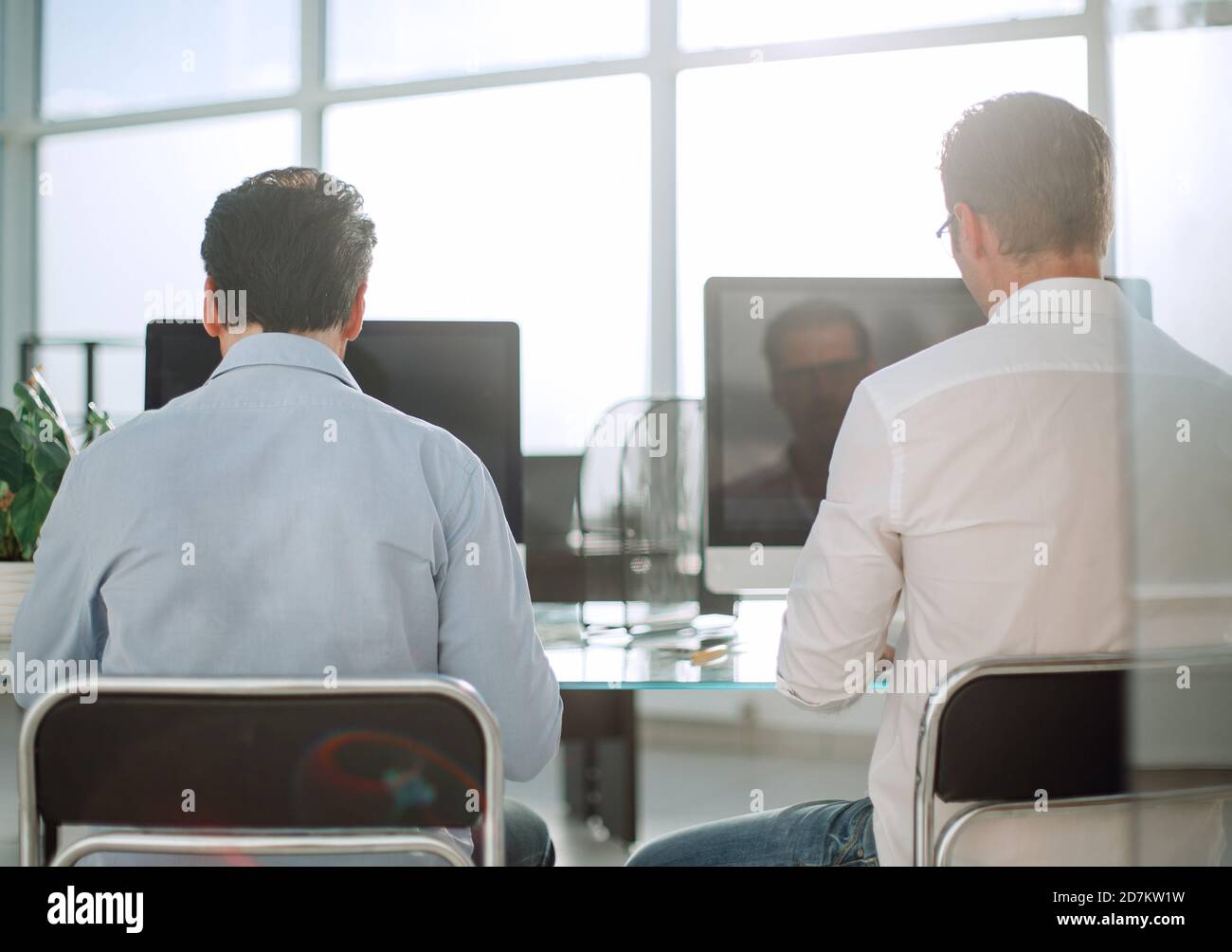 rear view.two business people working at the Desk Stock Photo - Alamy