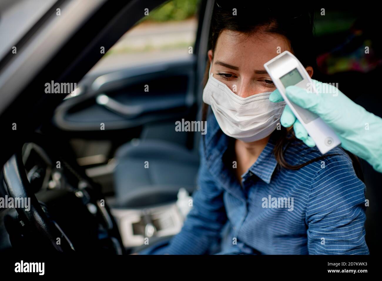 Checking body temperature for virus in a public place Stock Photo - Alamy