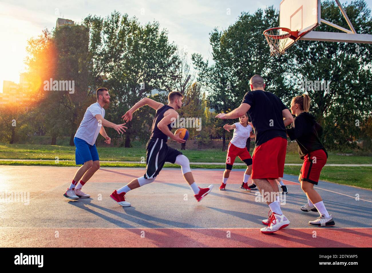 Group Of Young Friends Playing Basketball Match Stock Photo - Alamy