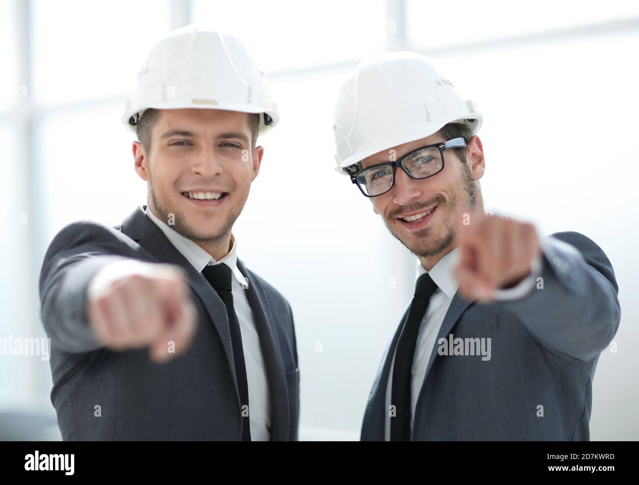 two builders are looking into the camera. concept of construction Stock ...