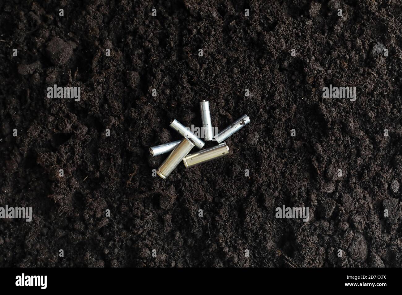 Batteries in the ground. Environmental pollution Stock Photo - Alamy