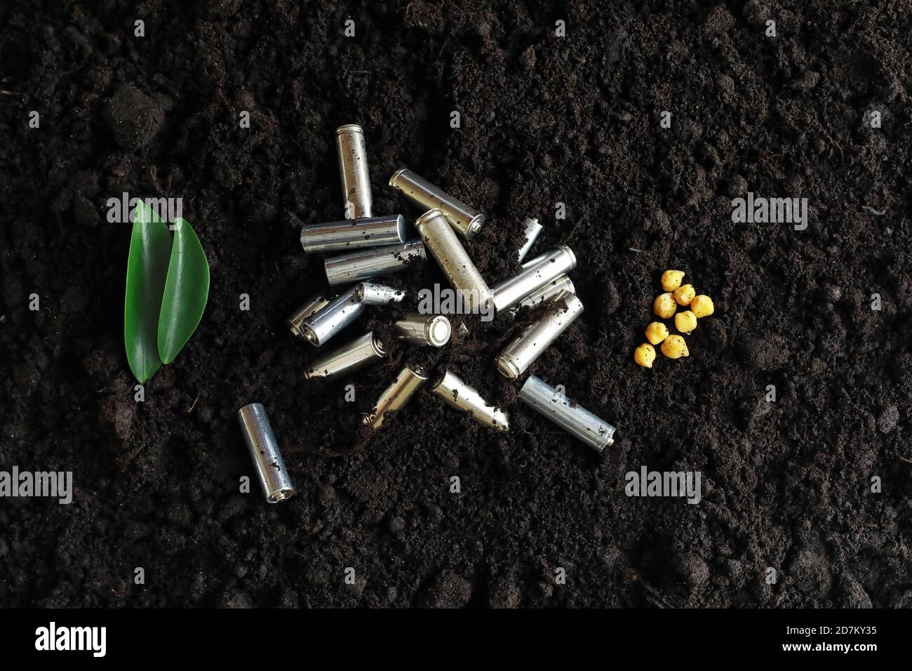 Batteries in the ground. Environmental pollution Stock Photo - Alamy