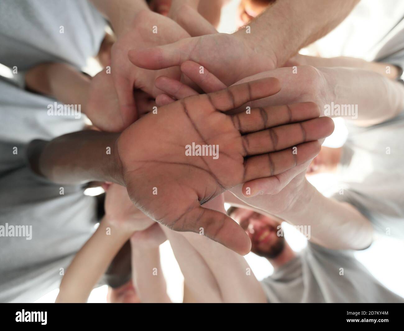 smiling young people making a tall tower out of their hands Stock Photo ...