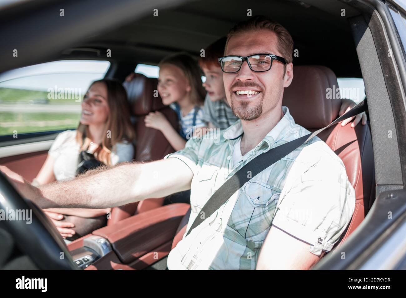 side view.happy family rides in the car Stock Photo - Alamy