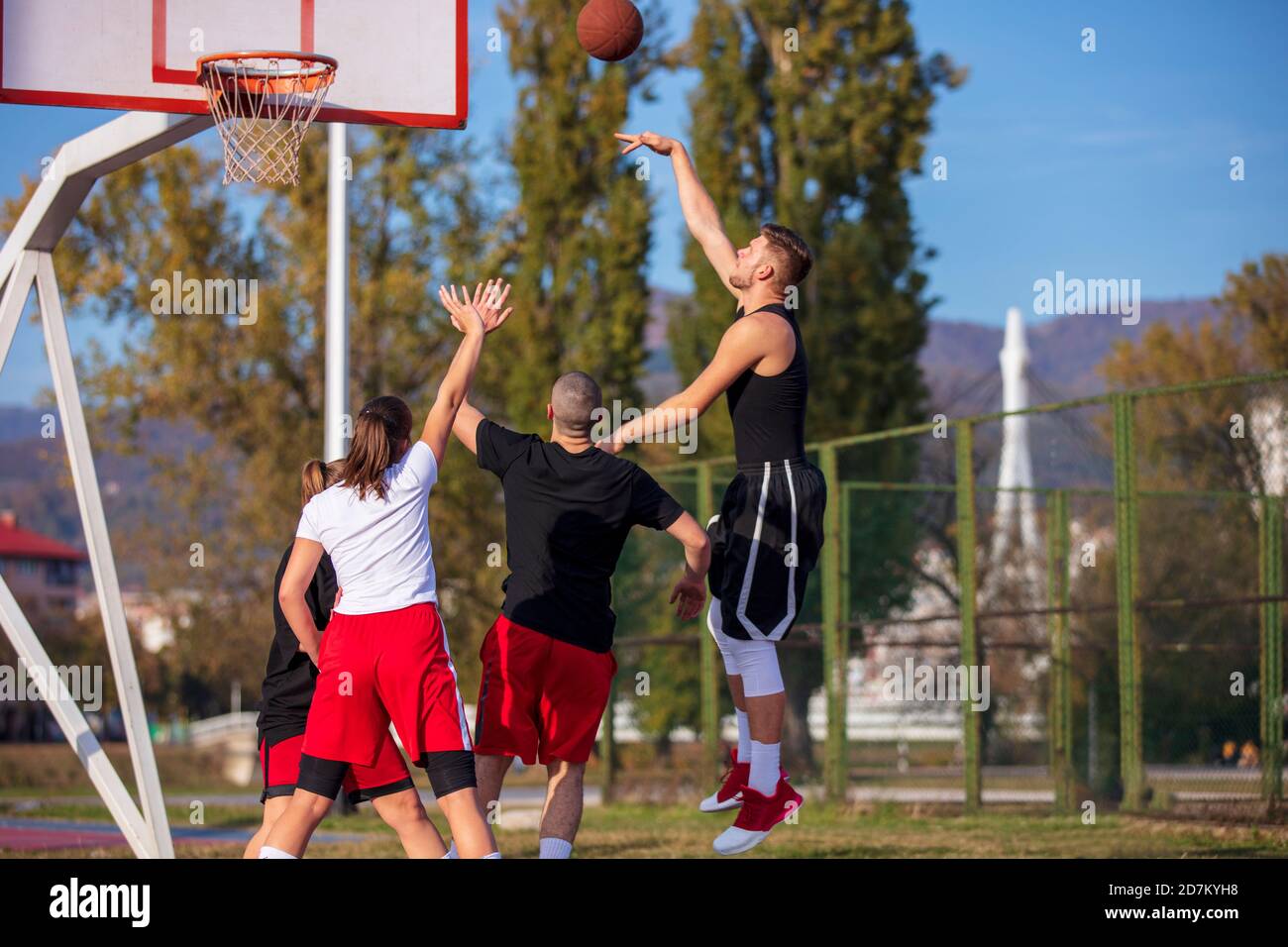 Group Of Young Friends Playing Basketball Match Stock Photo - Alamy