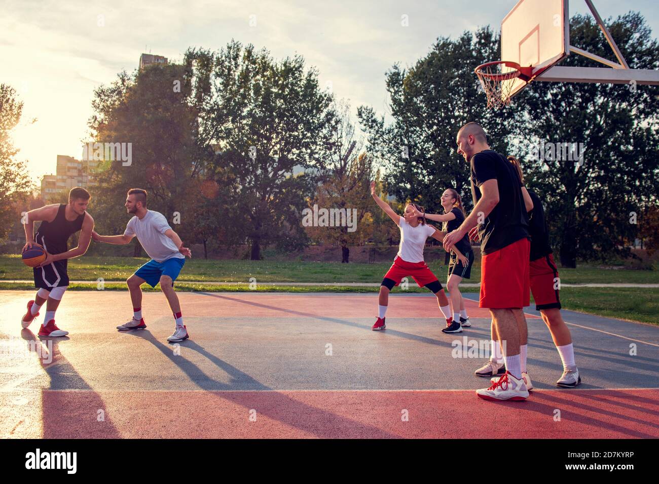 Group Of Young Friends Playing Basketball Match Stock Photo - Alamy
