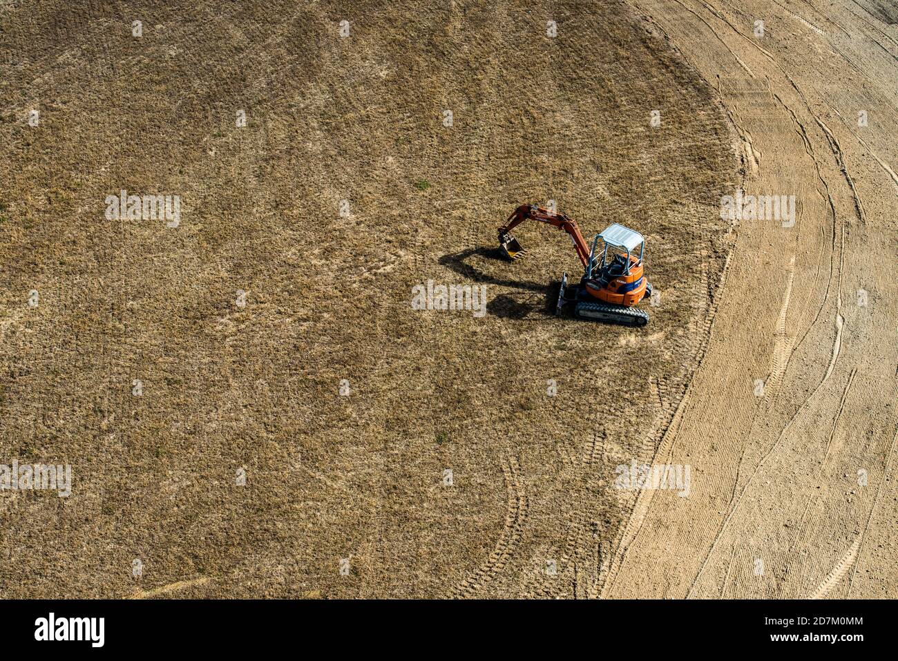 Overhead, aerial view of small back hoe in field Stock Photo - Alamy