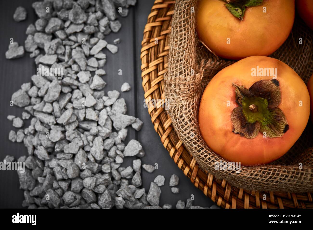sack of delicious persimmons on a wicker plate, a vintage wooden box ...